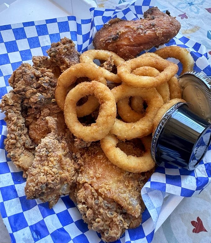 Golden fried chicken and crispy onion rings arrive like edible sunshine, demanding your immediate and undivided attention.