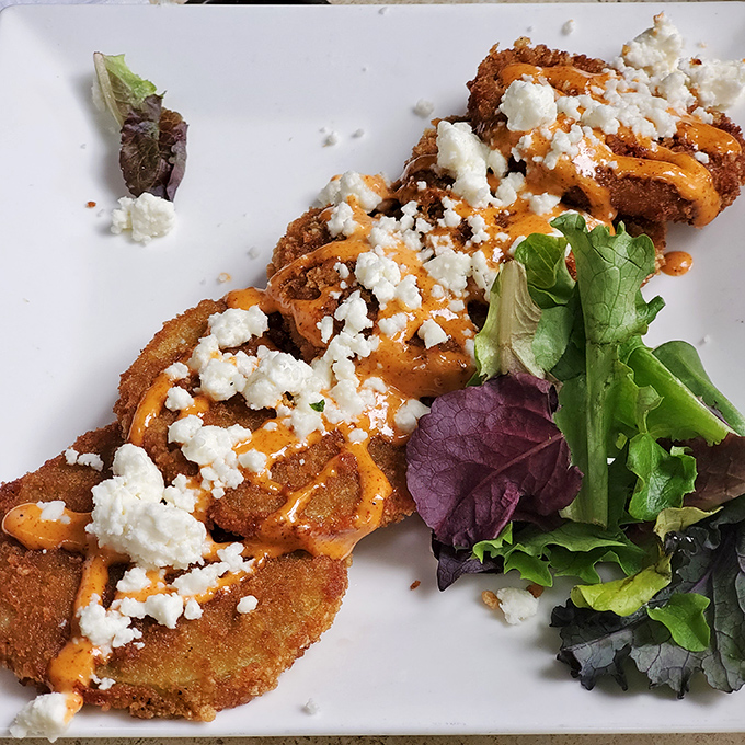 Fried green tomatoes get the royal treatment with goat cheese crumbles and a drizzle that makes these Southern classics ready for their close-up.