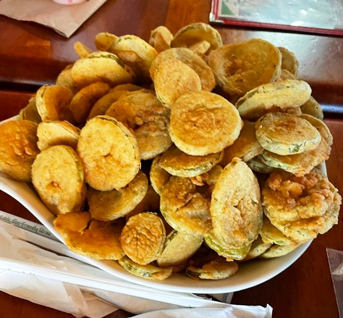 Golden-fried pickle chips stacked higher than your vacation reading list &ndash; a crunchy, tangy prelude to seafood bliss.