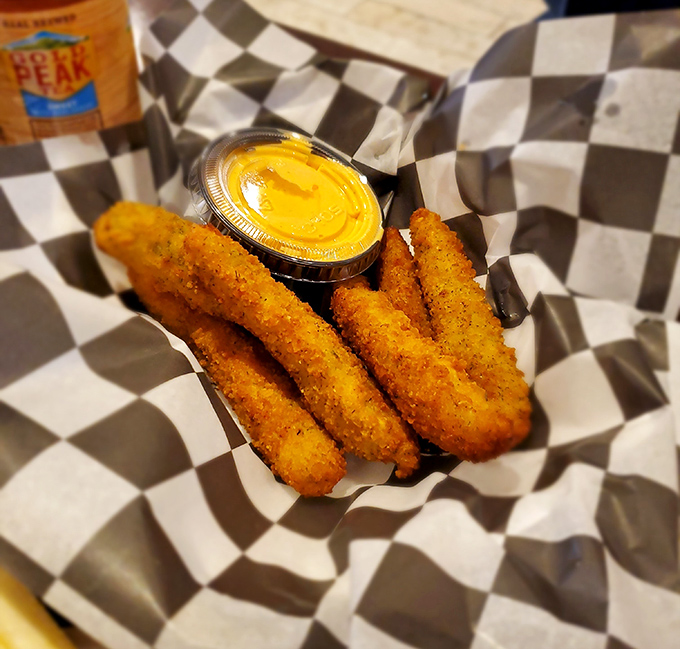 Golden-fried pickle spears with cheese sauce – because sometimes vegetables need to dress up and party too. Crunchy, tangy perfection awaits.