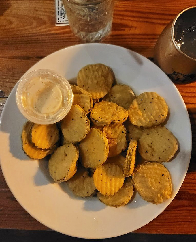 Fried pickles: the unsung heroes of bar snacks. Crispy, tangy discs of joy that somehow make beer taste even better.