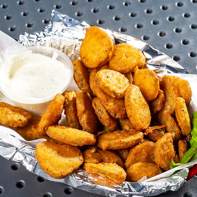Golden-fried pickle chips that shatter with each bite, served with cooling ranch. Whoever invented these deserves a Nobel Prize in Snackology.
