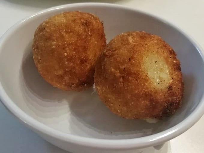 These golden arancini aren't just fried rice balls&mdash;they're time machines to Sicilian street corners where comfort food was perfected centuries ago. 
