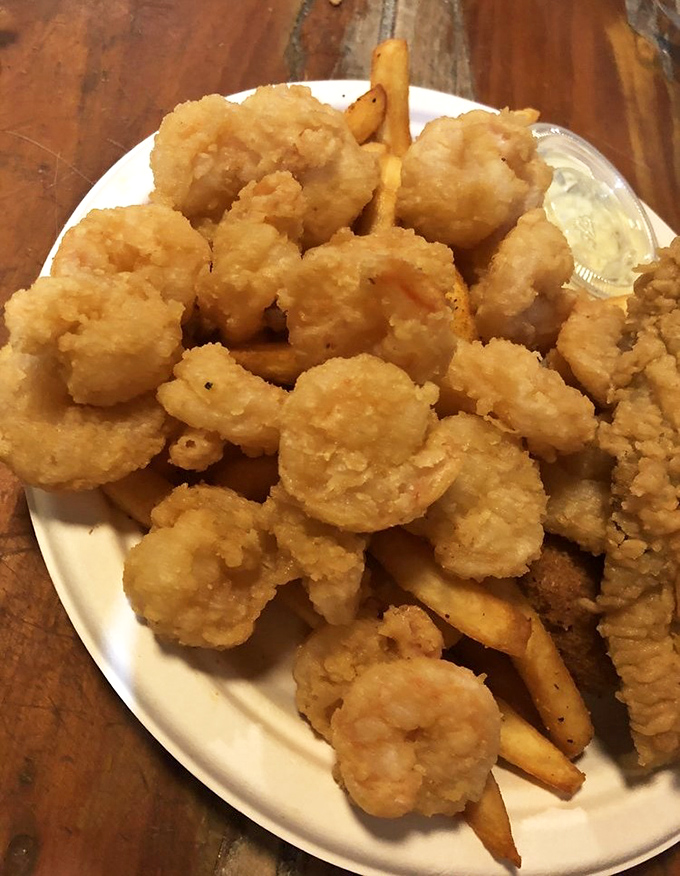 Golden-battered shrimp that crunch like autumn leaves, revealing sweet treasures within. The kind of fried perfection that makes diets willingly surrender.