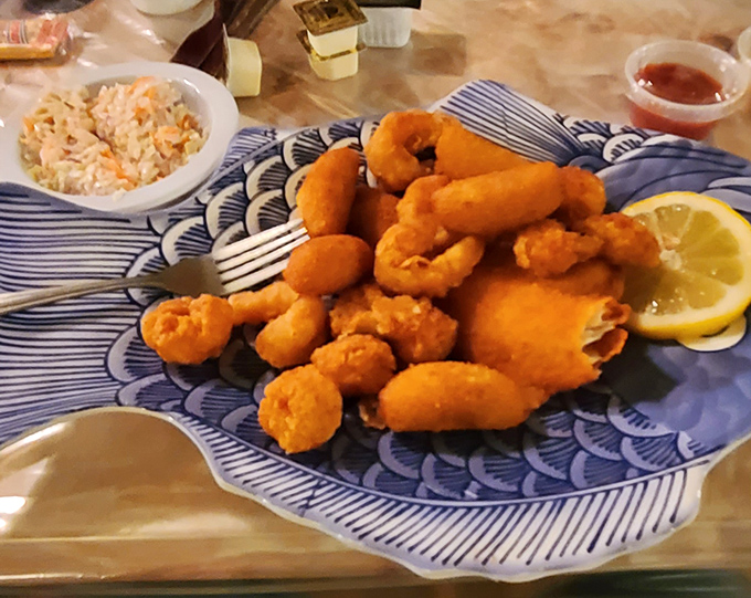 Golden-fried shrimp that crunch like childhood memories, nestled beside coleslaw that cuts through the richness perfectly.