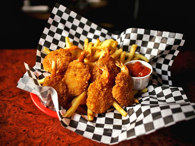 Golden-battered butterfly shrimp nestled among crispy fries &ndash; the kind of comfort food that makes you wonder why anyone bothered inventing molecular gastronomy.