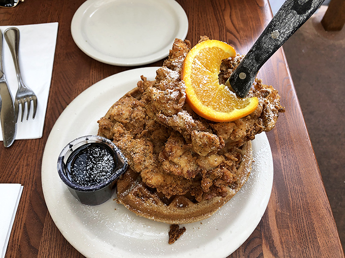The legendary chicken and waffle tower&mdash;architectural wonder meets flavor explosion. That knife standing triumphantly says, "Yes, you'll need tools for this adventure."