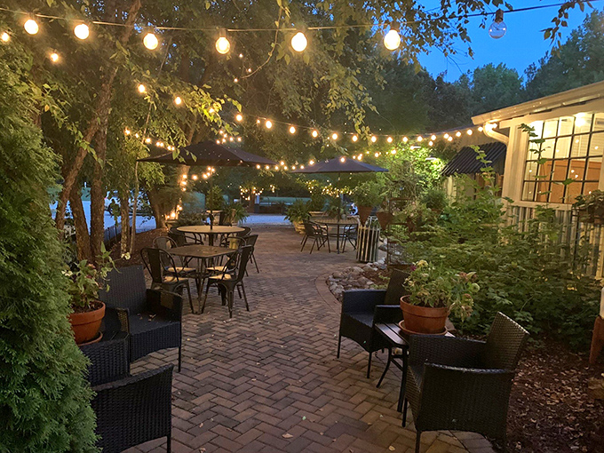String lights transform this garden patio into a magical dining sanctuary. When the sun sets, the conversation flows as freely as the sweet tea.