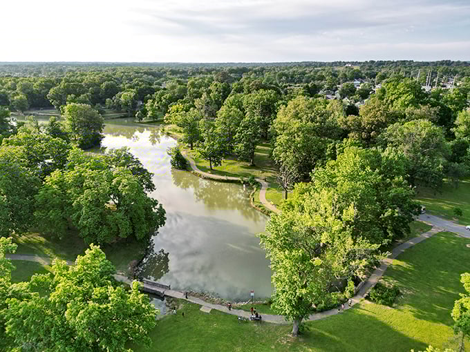 Aerial view of Garvin Park showcases Evansville's green heart, where generations have created memories around its winding paths and peaceful waters.