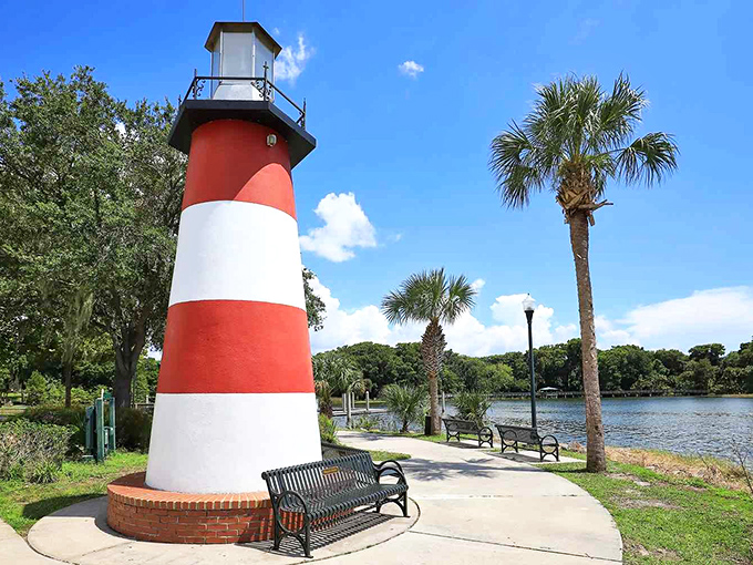 The red and white lighthouse at Grantham Point Park stands proudly beside a lake that's nowhere near an ocean—Florida's delightful geographic rebellion.