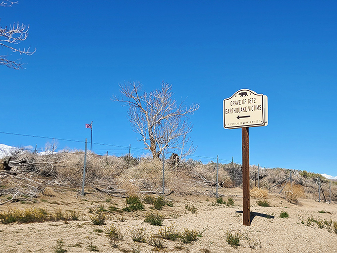 A solemn reminder of nature's power, this marker commemorates the 1872 earthquake victims in a landscape that continues to be shaped by geological forces.