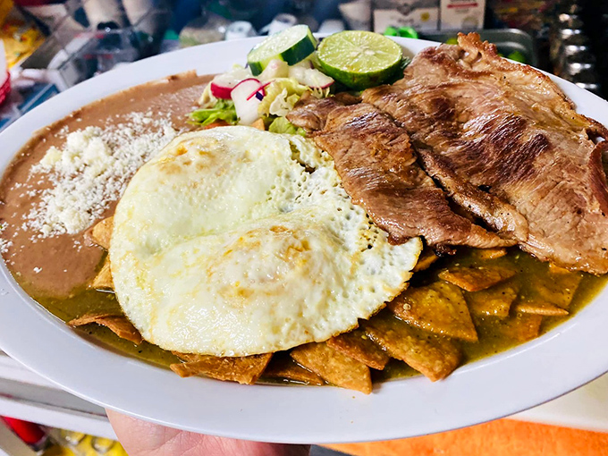 Chilaquiles verdes with steak and eggs—breakfast of champions or hangover cure? In this case, deliciously both.