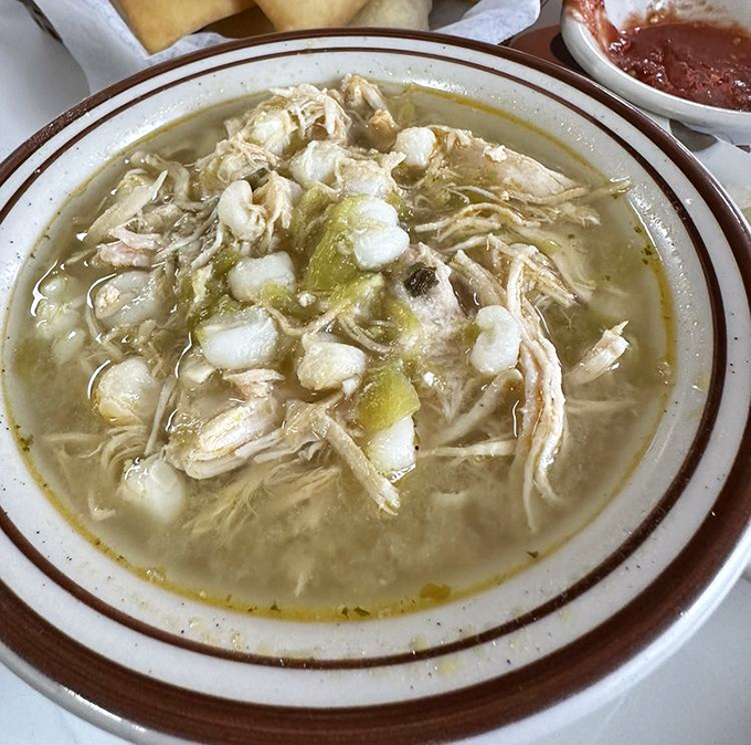 The Green Chili Posole arrives like a savory swimming pool of comfort &ndash; tender chicken, hominy, and green chiles dancing in harmony in every spoonful.