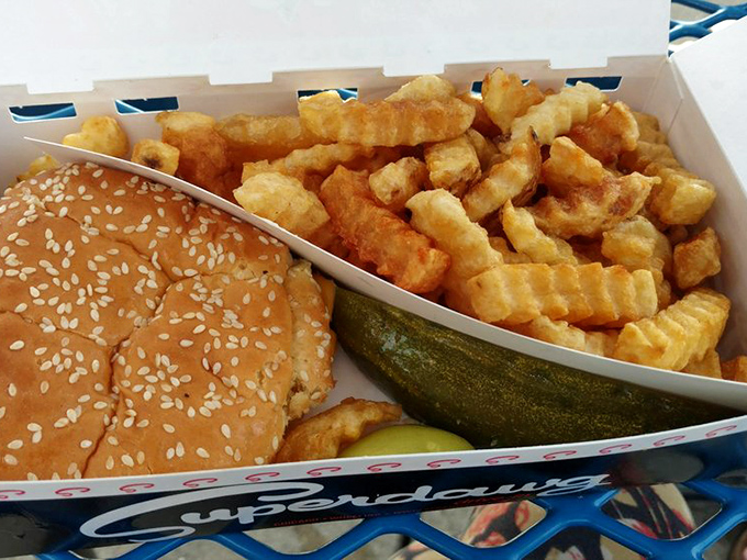 The crinkle-cut fries might steal the show if they weren't sharing the box with that perfectly golden sandwich and that pickle standing guard.