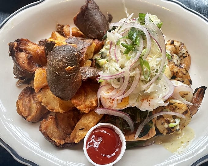 Home fries elevated to an art form, paired with perfectly grilled shrimp. That little cup of ketchup is about to embark on the adventure of its life.