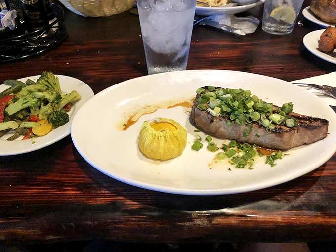 A perfectly seared tuna steak that's dressed for success with green onions and a corn husk boat of butter&mdash;seafood fashion at its finest.