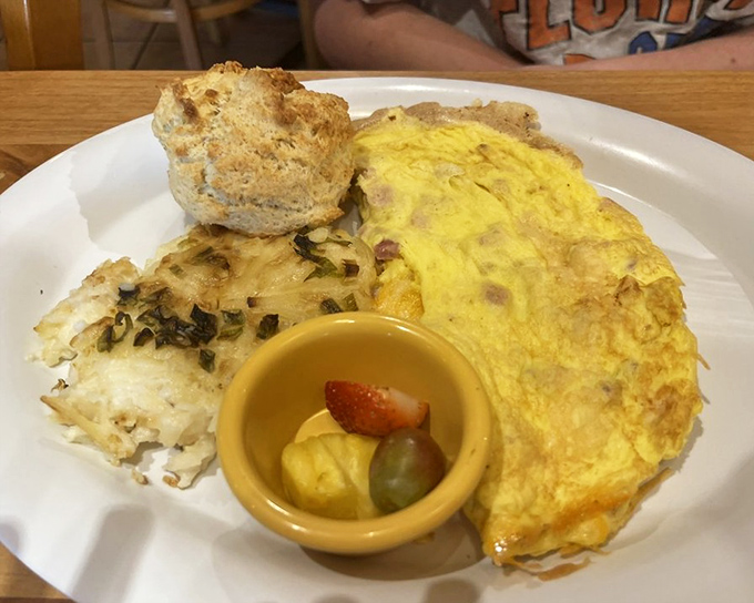 An omelet should be a fluffy cloud cradling treasures within &ndash; this golden creation delivers with a side of biscuit that's practically begging for butter.