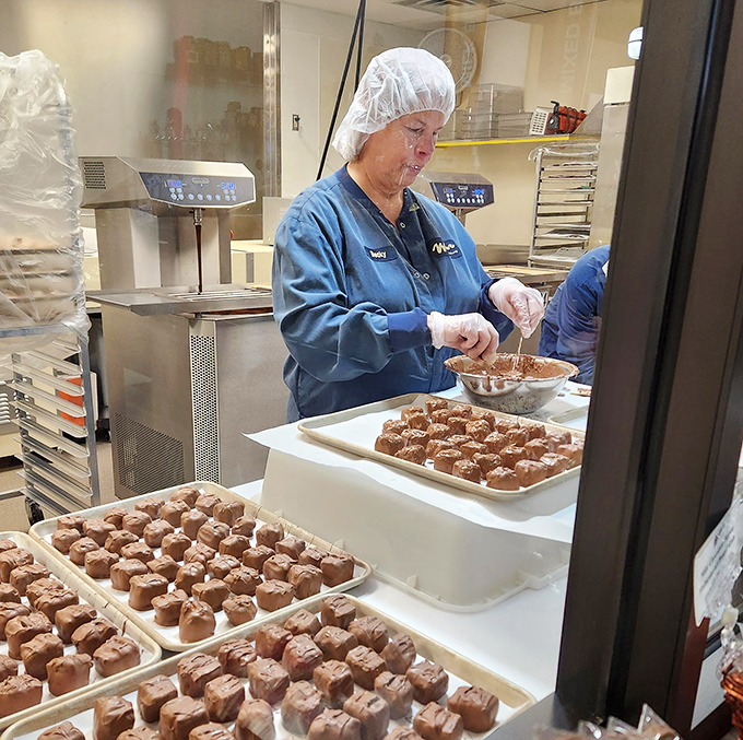 Behind glass, artisans transform liquid chocolate into edible art. It's like watching a sculptor, except this masterpiece disappears delightfully in your mouth.