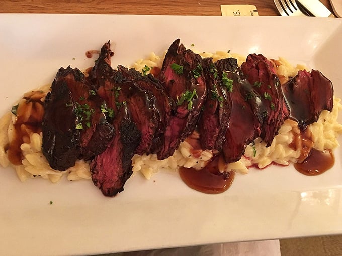 Perfectly sliced hanger steak over risotto&mdash;proof that sometimes the best things in life come arranged in neat rows atop creamy carbs. 