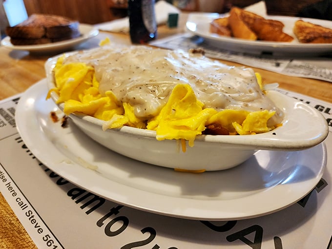 A beautiful marriage of cheese, eggs and potatoes smothered in country gravy. This isn't just breakfast &ndash; it's emotional support in bowl form.