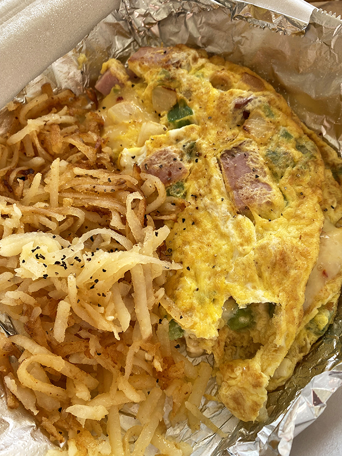 This isn't just an omelet with hash browns&mdash;it's breakfast architecture. The crispy potato foundation supporting a fluffy egg masterpiece.