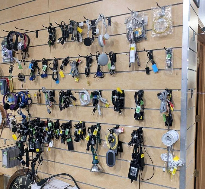 A tangle of technological history hangs in suspended animation. Each cord and adapter tells the story of our rapidly evolving digital world.