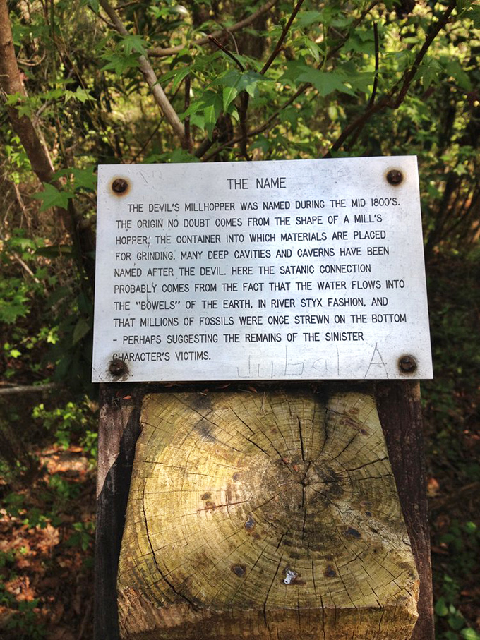 History carved in stone – this weathered sign explains why early settlers thought the devil might be collecting souls through this limestone funnel.