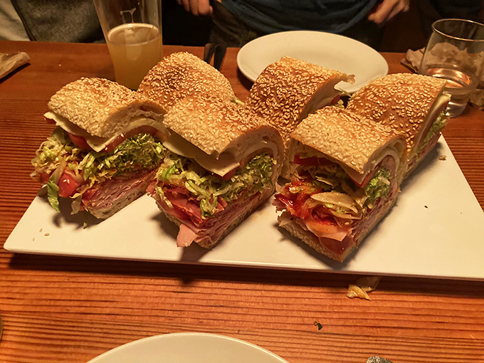 These aren't just sandwiches; they're architectural marvels of flavor. The sesame-studded bread alone deserves its own fan club.