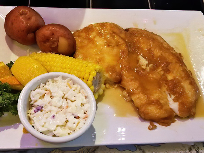 Golden-fried hogfish with a side of coleslaw and corn—proof that sometimes the simplest preparations let exceptional seafood shine brightest.