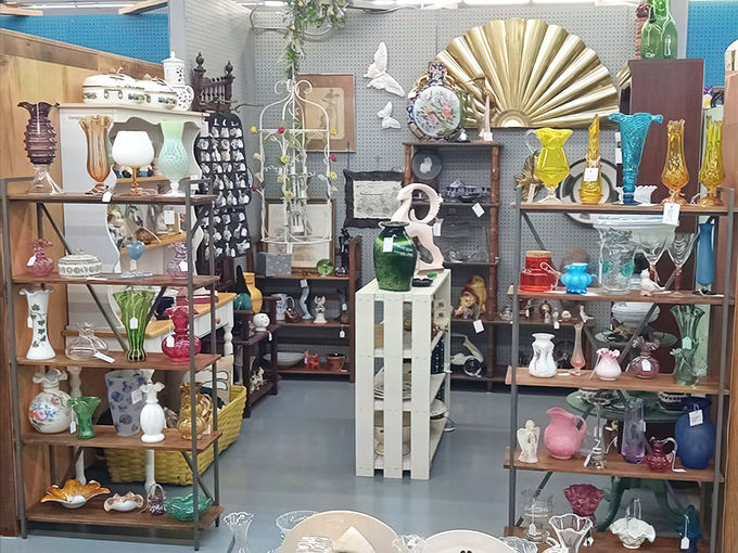 A rainbow of vintage glassware catches the light like jewels. Collectors know this aisle is where wallets open and willpower crumbles. 