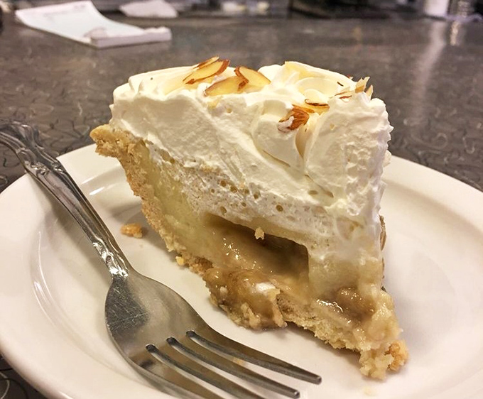 Homemade banana cream pie that would make your grandmother both proud and jealous, topped with a cloud of whipped cream that deserves its own zip code.