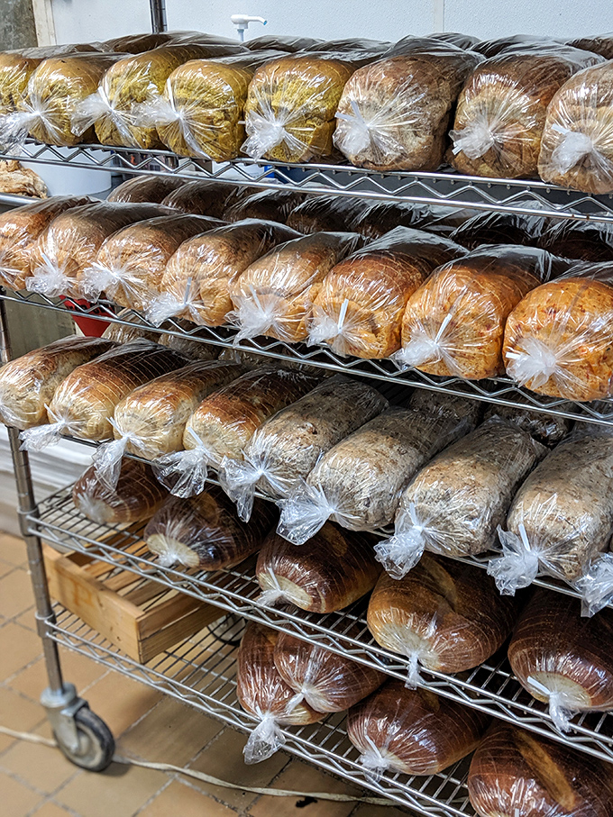 Fresh loaves lined up like edible soldiers, each one a testament to the ancient art of fermentation.
