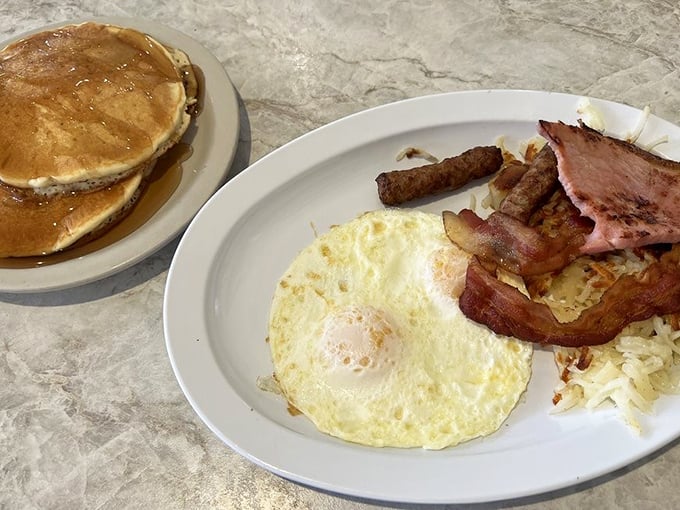 The breakfast trinity: perfectly sunny-side-up eggs, crispy bacon, and golden pancakes&mdash;proof that simplicity is the ultimate sophistication.