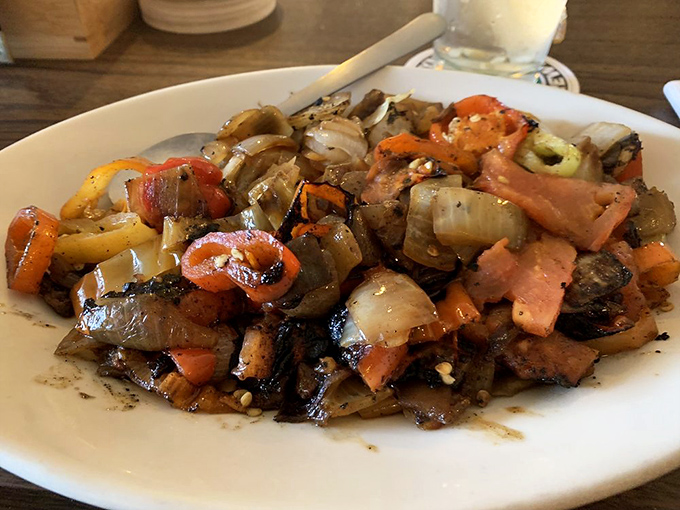 Colorful saut&eacute;ed peppers and onions that would make any steakhouse jealous&mdash;proof that even the sides get star treatment here.
