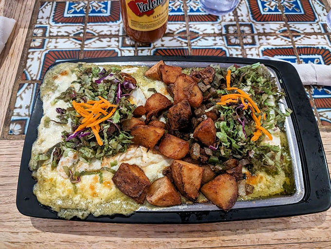 Huevos rancheros arrive like edible sunshine, topped with roasted potatoes that could convert any breakfast skeptic instantly.
