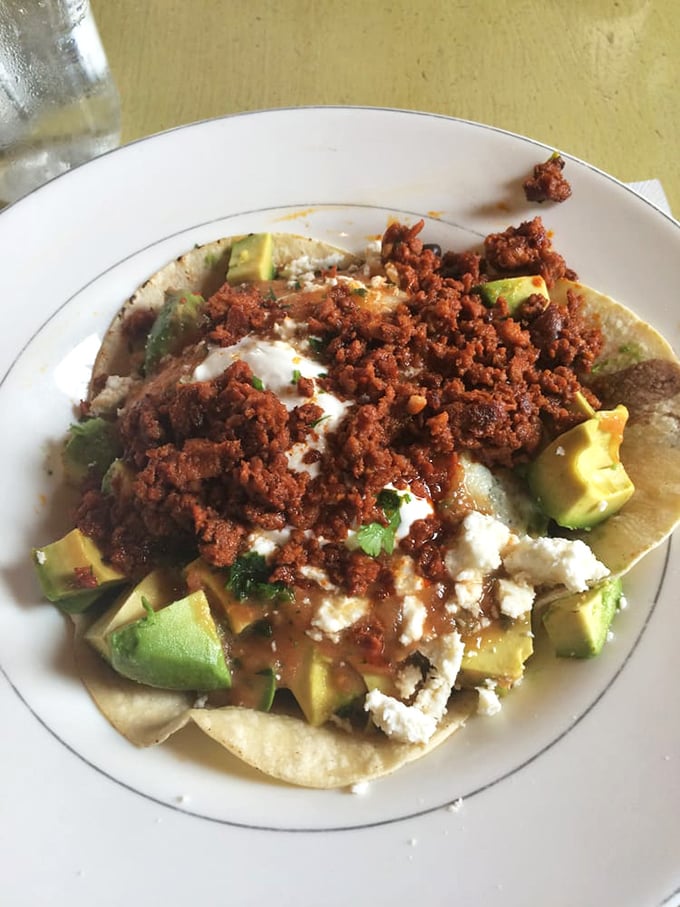 These aren't your average huevos rancheros&mdash;they're a fiesta of textures with creamy avocado, crumbled cheese, and chorizo that demands to be savored.