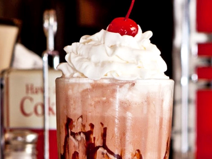 Chocolate shake perfection topped with whipped cream and a cherry. One sip and suddenly you're wearing saddle shoes and planning to go steady.