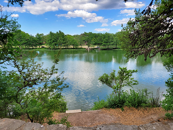 The glassy waters of Kerrville-Schreiner Park reflect clouds that look like they were painted by Bob Ross after a particularly inspired day.