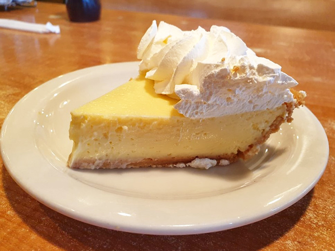 The pale yellow hue doesn't lie&mdash;this is authentic key lime pie, not the neon green imposters. That whipped cream crown deserves a royal salute.