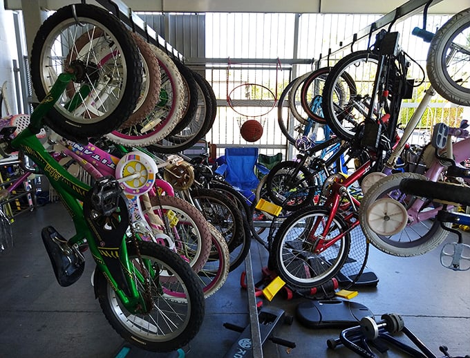 A bicycle graveyard? No, a two-wheeled resurrection center! Tomorrow's neighborhood champion might find their first set of wheels right here among this colorful tangle.