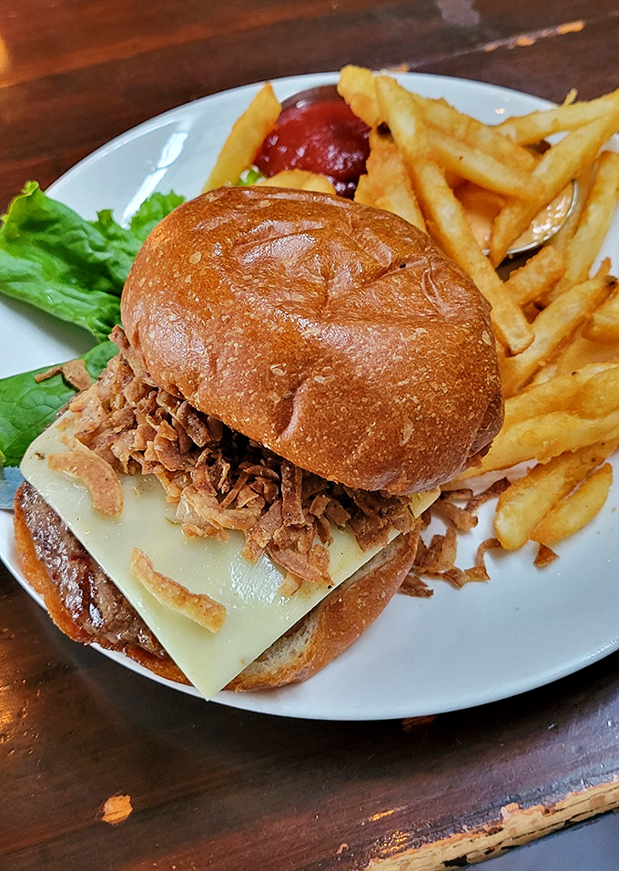 This burger isn't just a meal, it's an architectural achievement with crispy onions that deserve their own fan club.