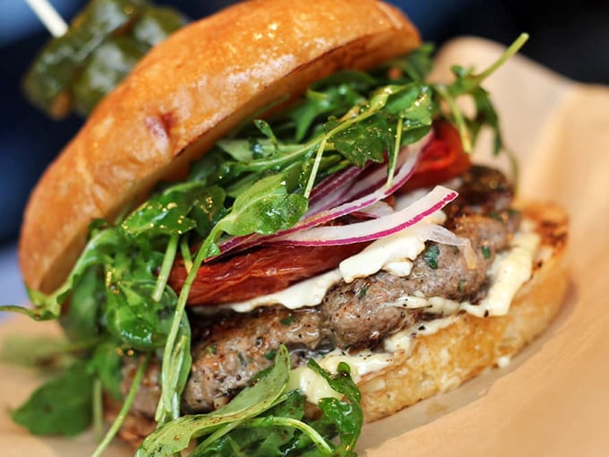 This Lamb Burger doesn't just break the rules&mdash;it rewrites them. Fresh arugula and roasted tomato create a Mediterranean symphony in West Sacramento.