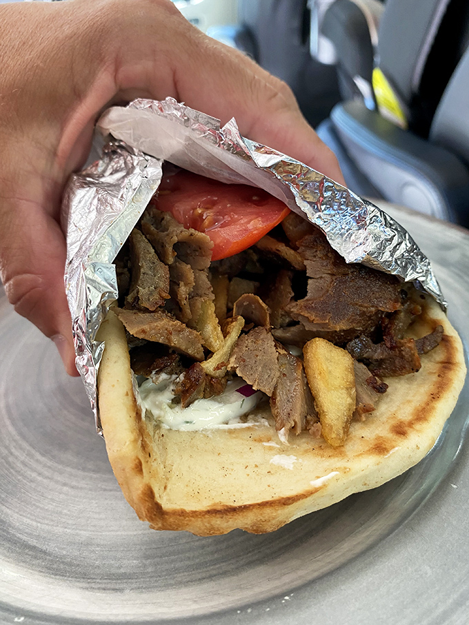 Behold the architectural marvel that is a proper gyro! Layers of savory lamb, fresh veggies, and tzatziki, all wrapped in pillowy pita. Napkins required, regrets impossible.