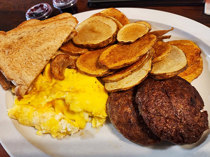 Breakfast of champions! Eggs, home fries, sausage patties, and toast—the kind of hearty morning fuel that built the Midwest, one hungry worker at a time.