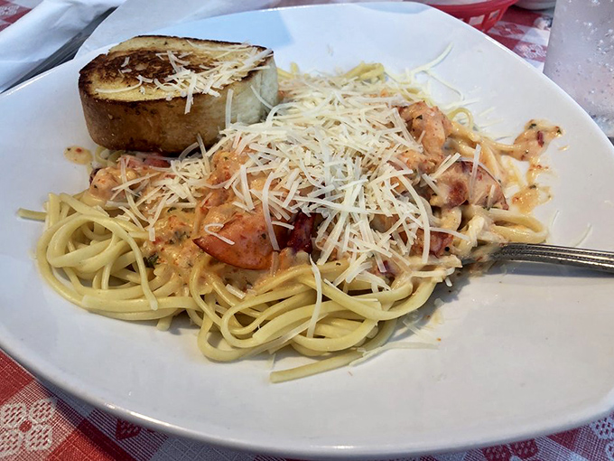 Pasta perfection achieved! Plump shrimp nestled in linguine with a shower of Parmesan and garlic toast for essential sauce-sopping duties.