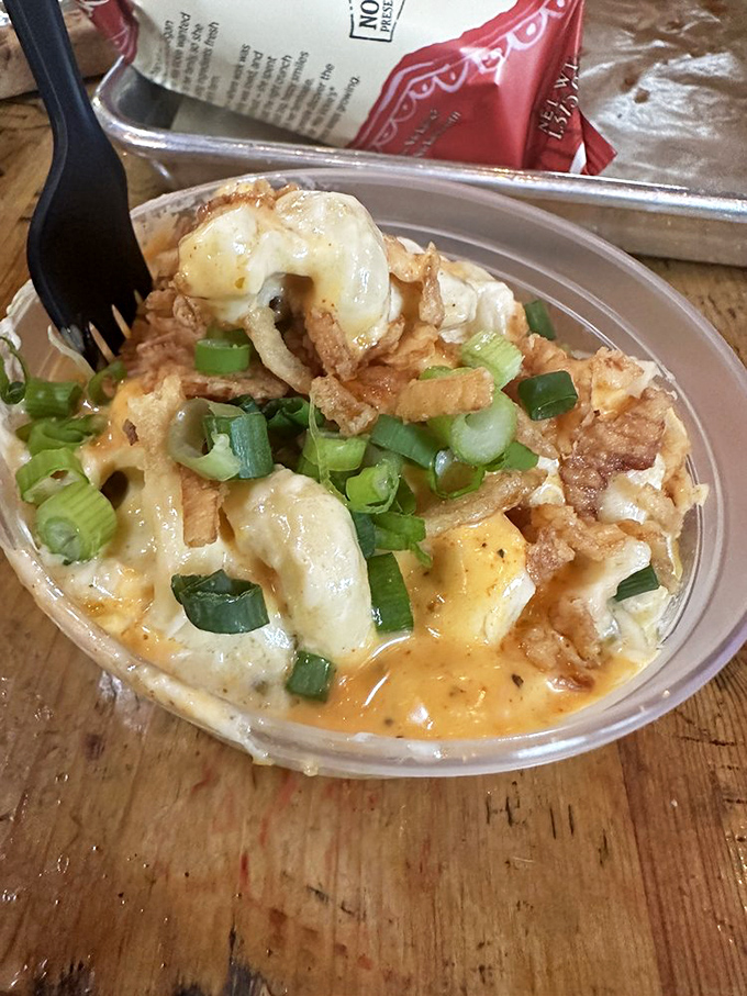 Mac and cheese transcends to art form with this creamy, indulgent creation. The crispy topping and green onions provide textural contrast that makes each bite a journey.