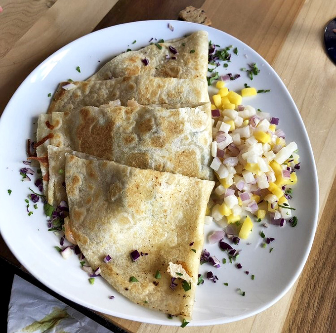 Golden-crisp quesadillas paired with a vibrant mango salsa&mdash;proof that sometimes the simplest combinations create the most memorable symphonies of flavor.