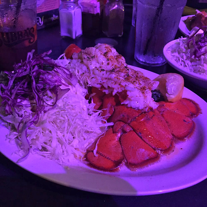 Purple lighting can't disguise this plate's star power – lobster and shrimp sharing the spotlight like the Hepburn and Tracy of seafood duos.