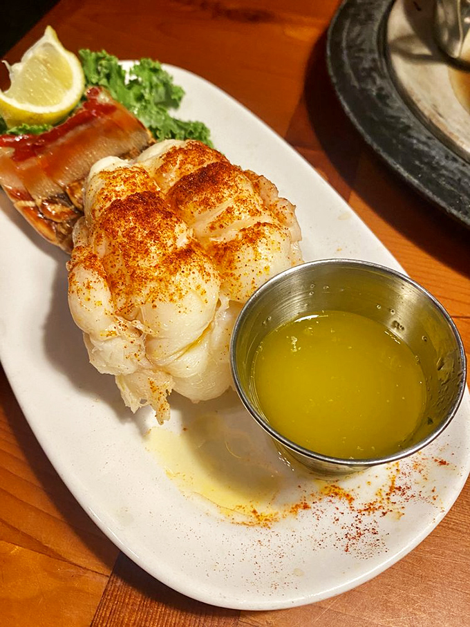 The star of the show: a butterflied lobster tail that's been kissed by fire and served with liquid gold butter. Neptune's finest treasure on a plate.