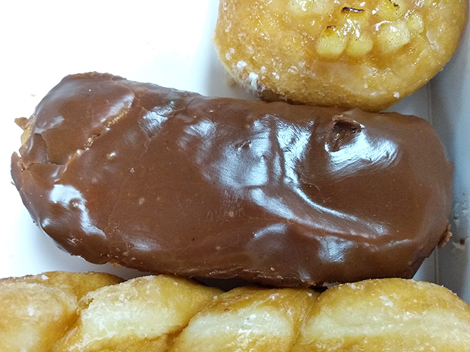 That chocolate coating gleams like a sugary mirror, reflecting all your best breakfast decisions back at you.